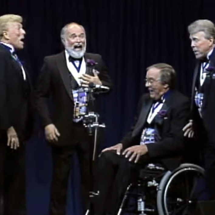 Four senior gentlemen perform delightfully cheerful barbershop quartet song