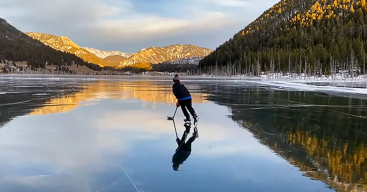 Two kids practice their hockey skills on a frozen Quake Lake